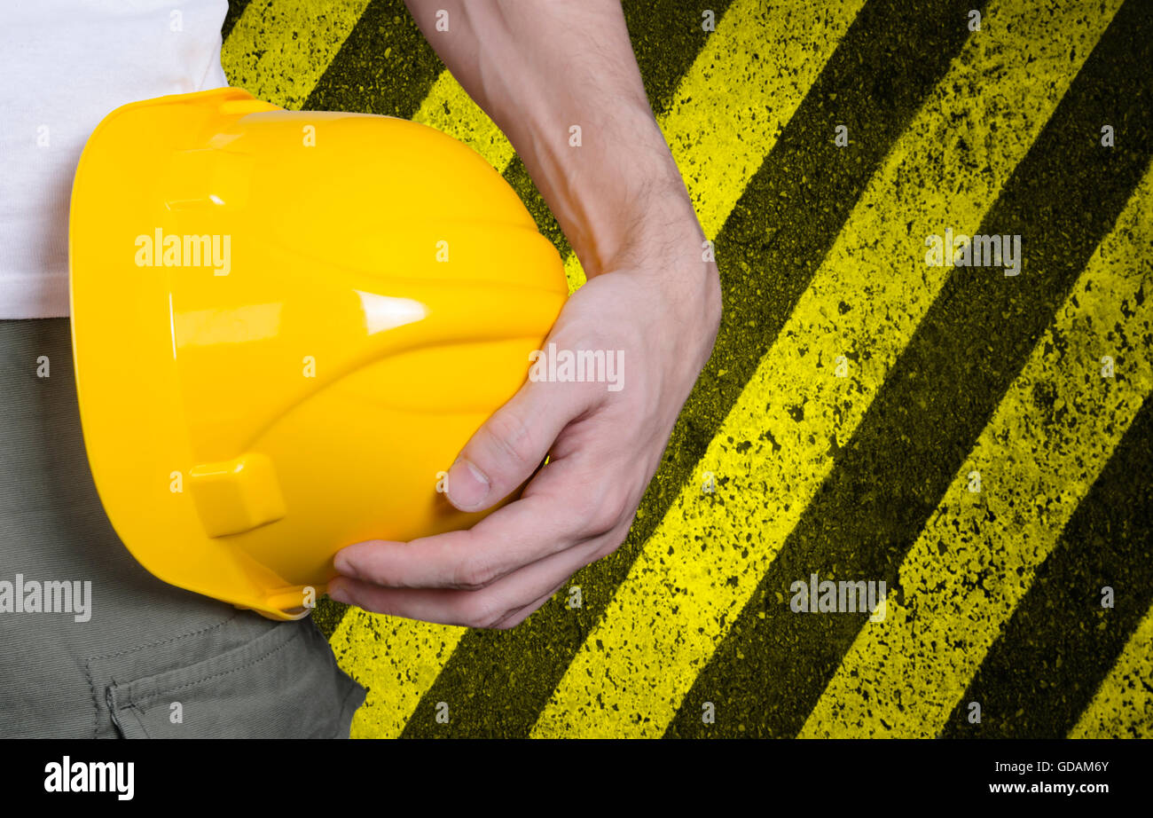 Worker with yellow conctruction helmet Stock Photo - Alamy