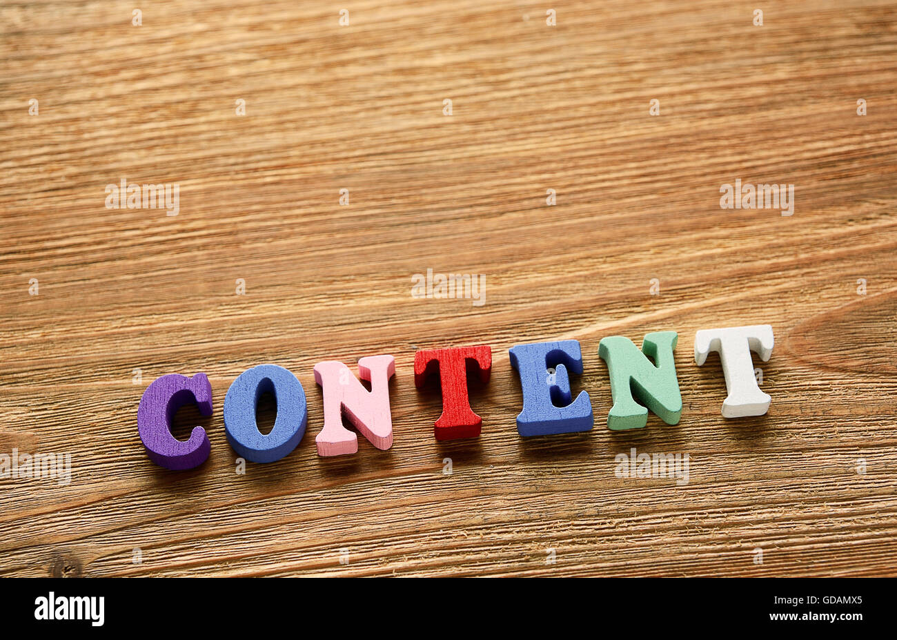 CONTENT - words made from multicolored letters on wooden background ...