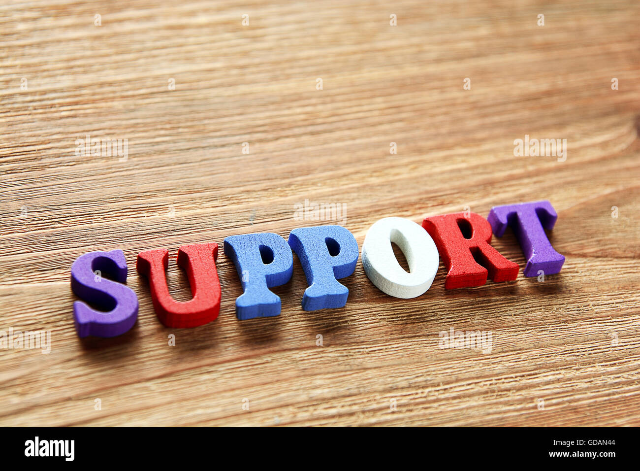 SUPPORT - word made from multicolored child toy letters on wooden ...