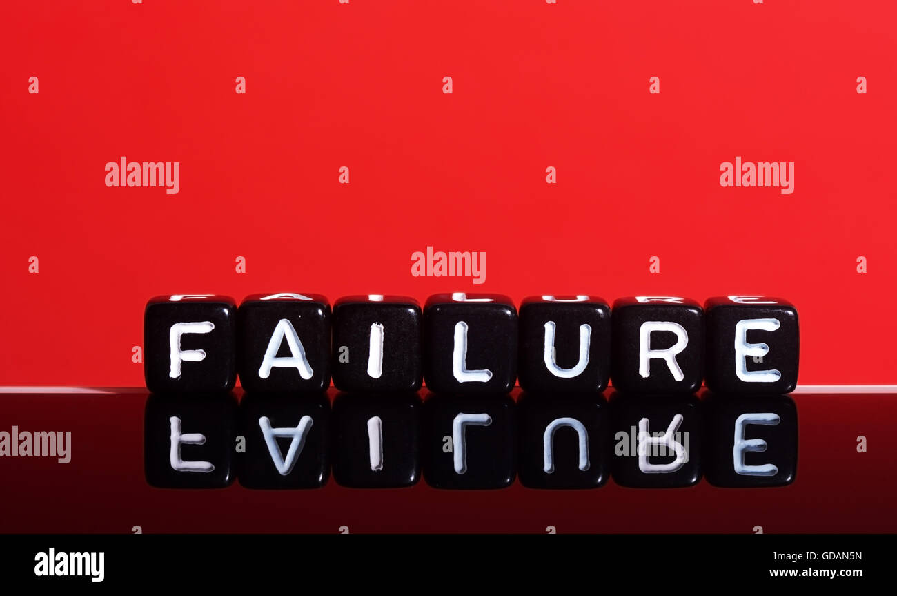 Failure text written on black cubes on red background Stock Photo - Alamy