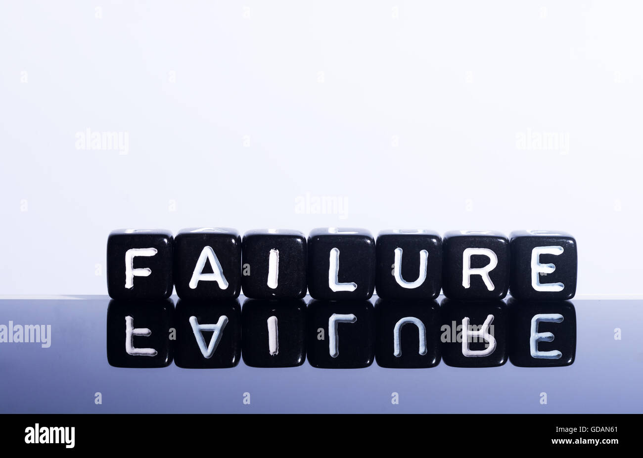 Failure text written on black cubes on white background Stock Photo - Alamy