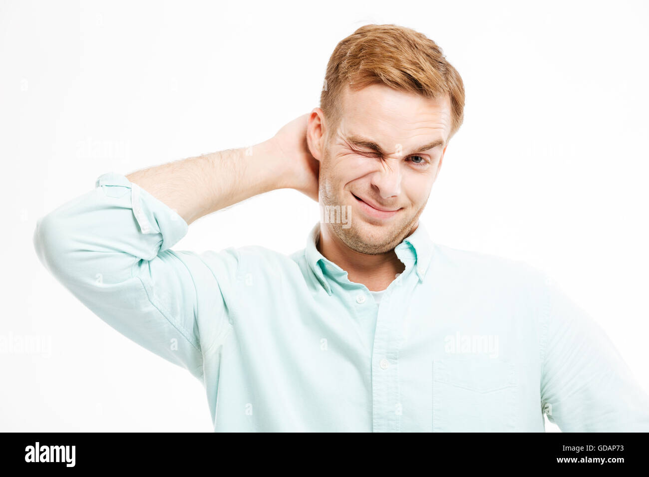 Lazy handsome young businessman standing and scratching his head over ...