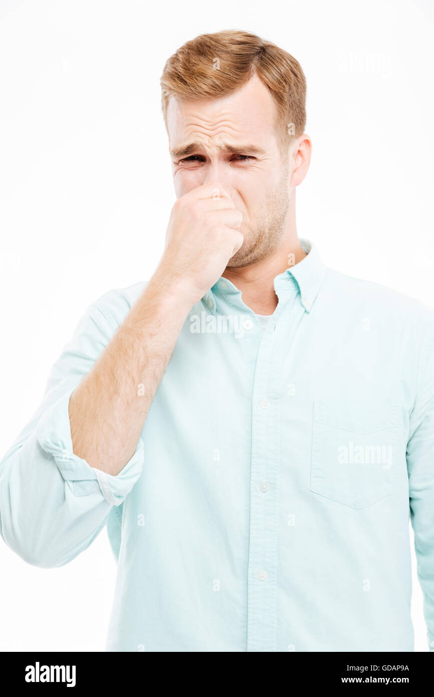Sad unhappy young businessman closed his nose by hand and feeling bad ...