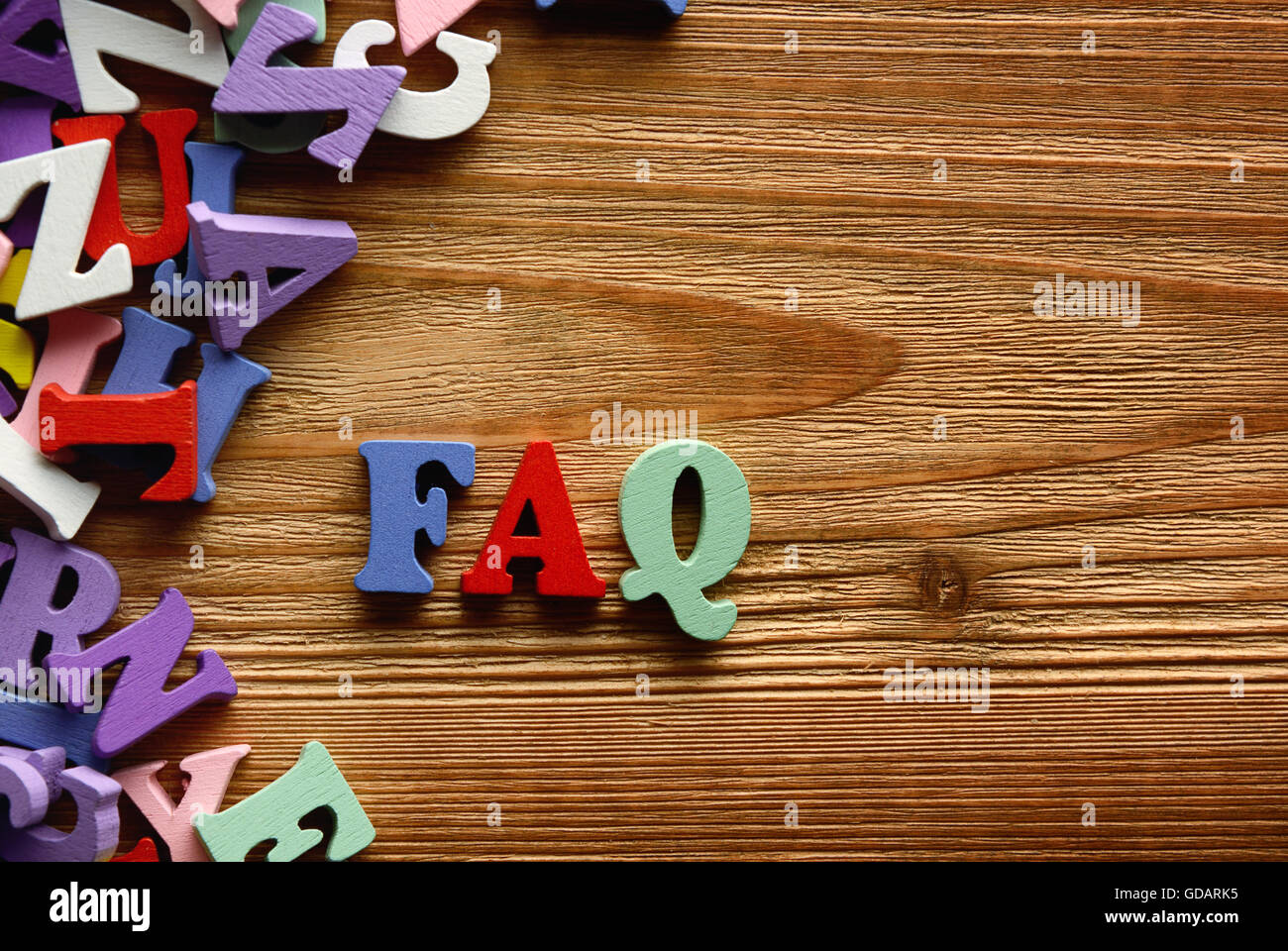 FAQ- words made from multicolored letters on wooden background Stock ...