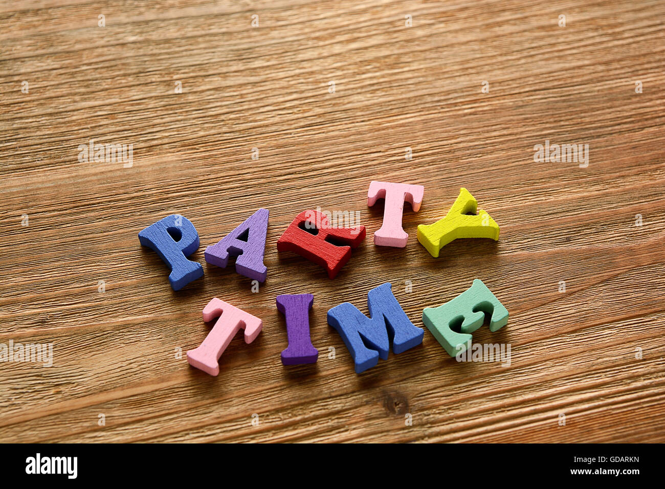 party time - words made from multicolored letters on wooden background ...