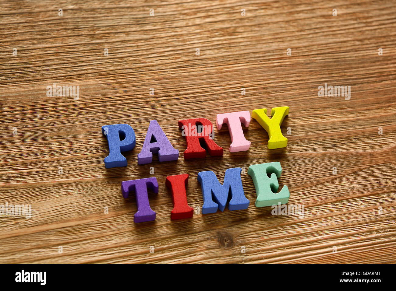 party time - words made from multicolored letters on wooden background ...