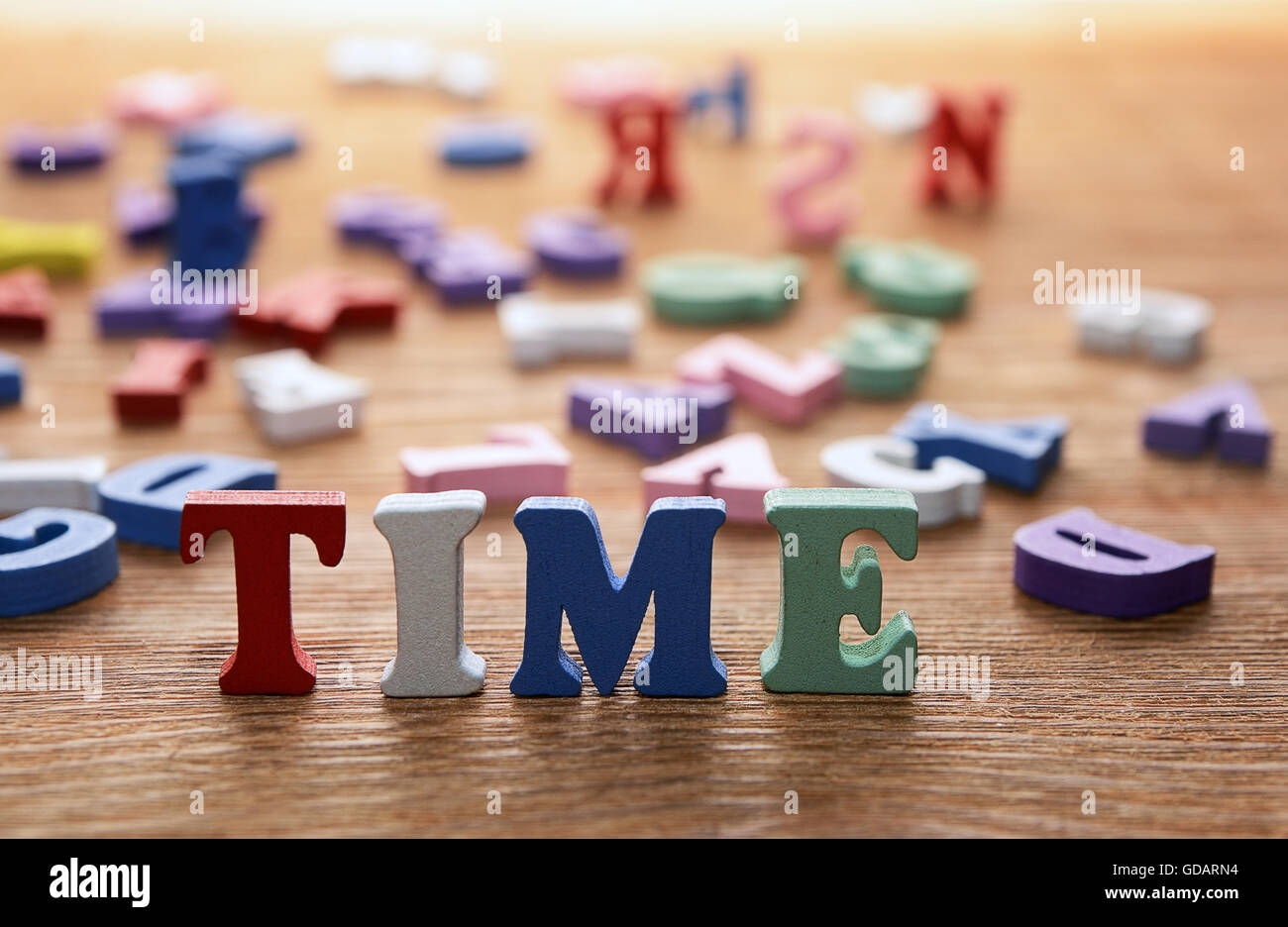 TIME - words made from multicolored letters on wooden background Stock ...