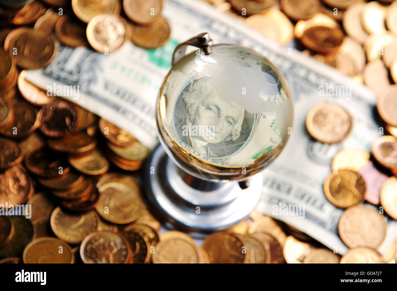 Glass globe and reflection of dollar bill and pile of coins Stock Photo ...