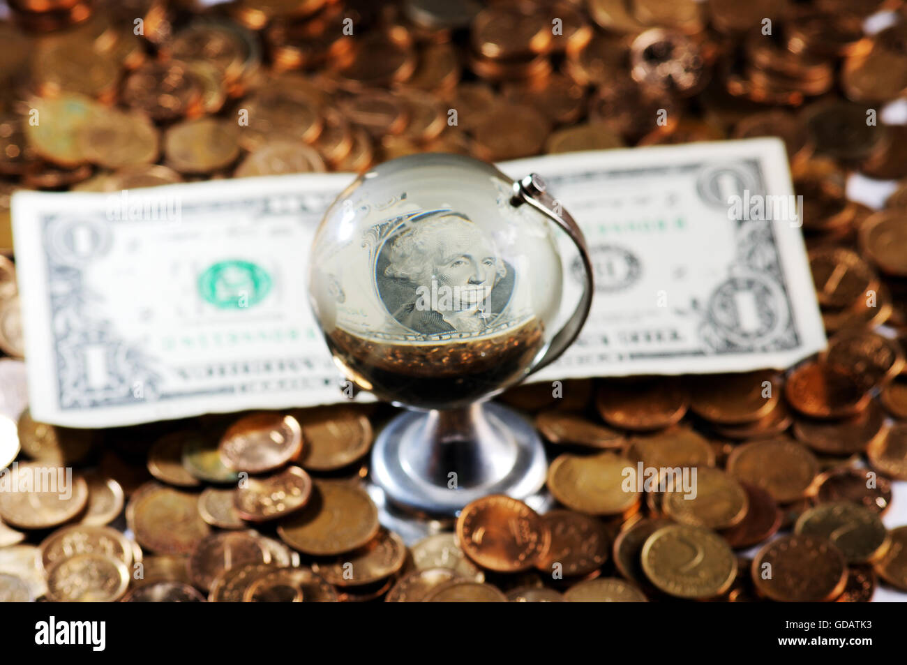 Glass globe and reflection of dollar bill and pile of coins Stock Photo ...