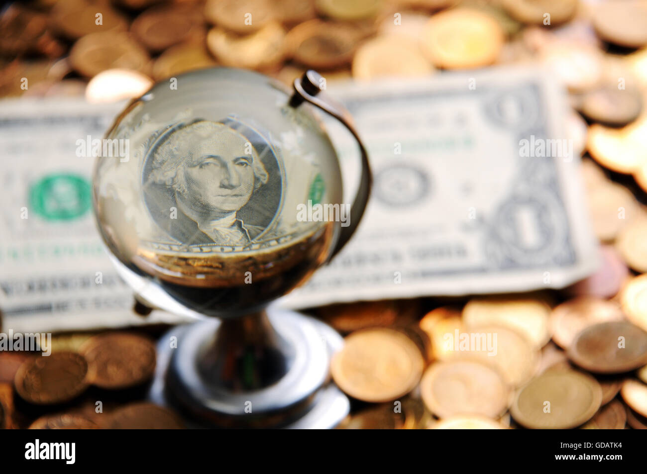 Glass globe and reflection of dollar bill and pile of coins Stock Photo ...