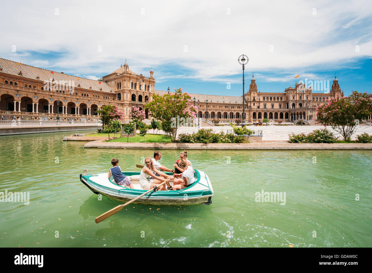 Seville, Spain - June 24, 2015: Tourists float on a boat on the canal ...