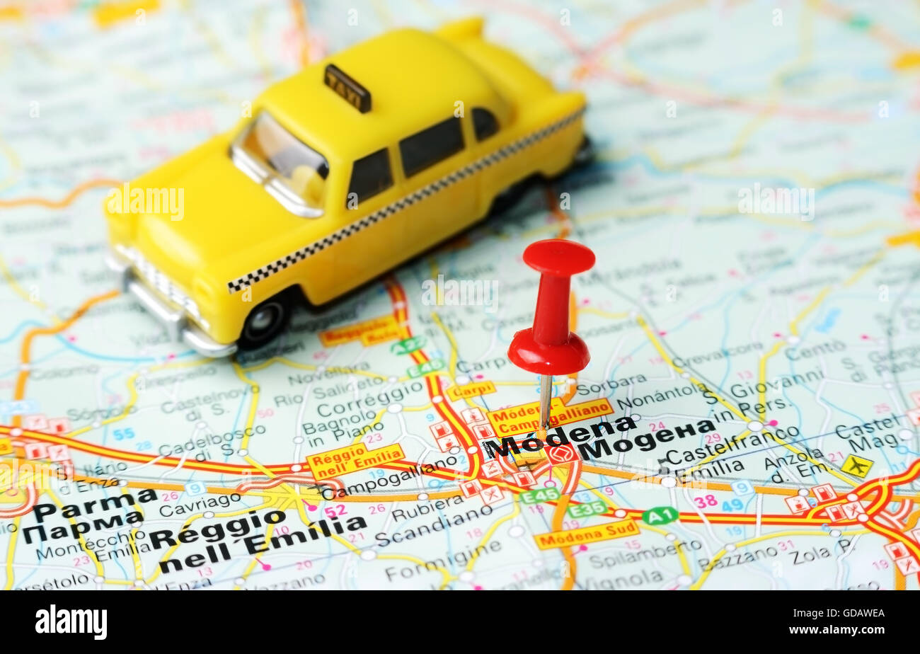 Close up of Modena , Italy map with red pin and a taxi - Travel concept ...