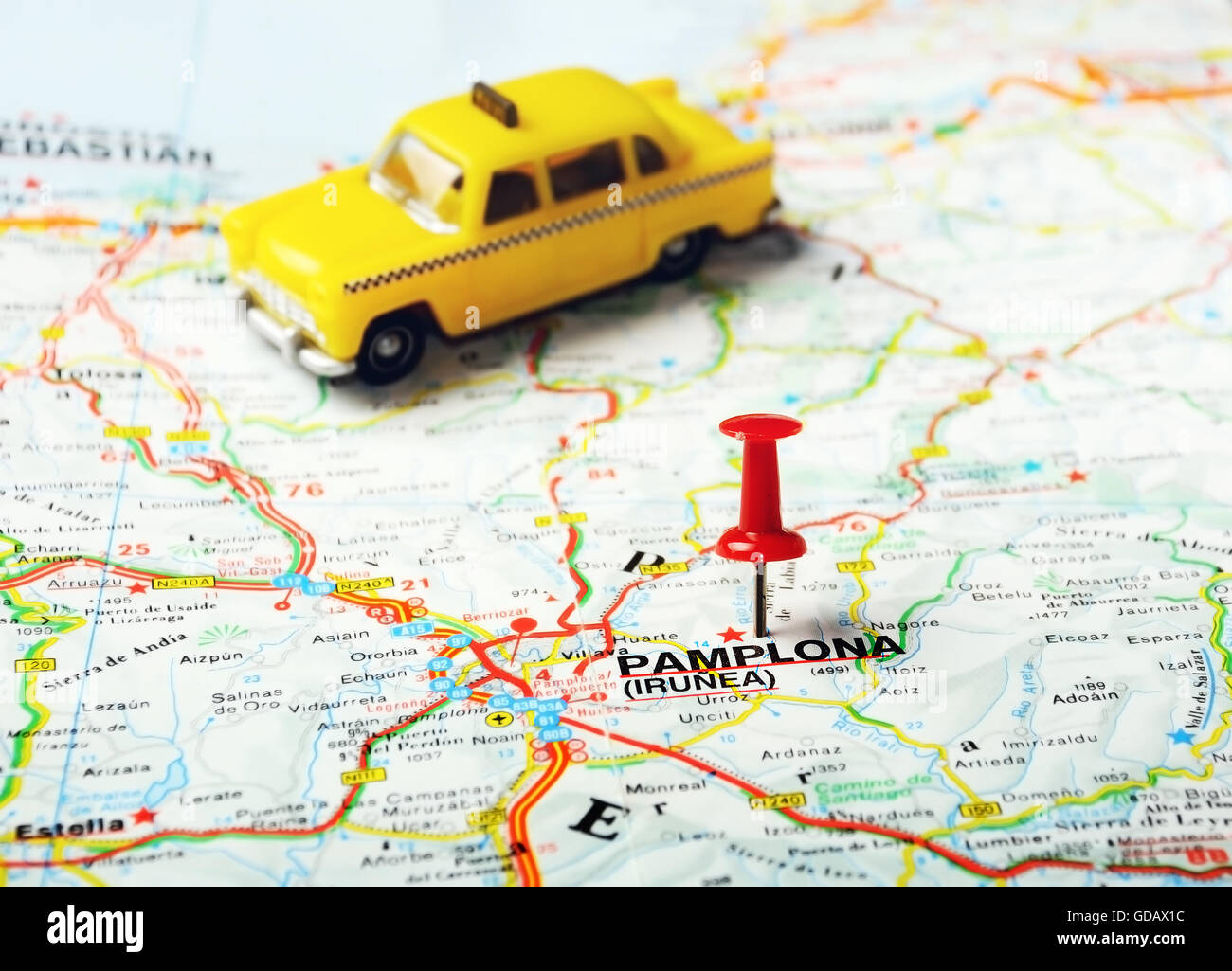 Red push pin pointing at Pamplona ,Spain map and a taxi Stock Photo - Alamy