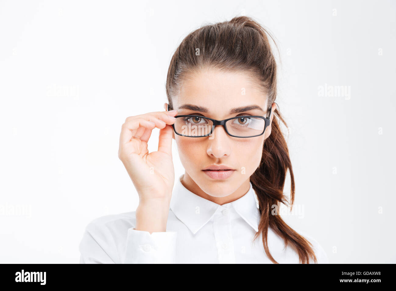 Serious girl looking over glasses hi-res stock photography and images ...