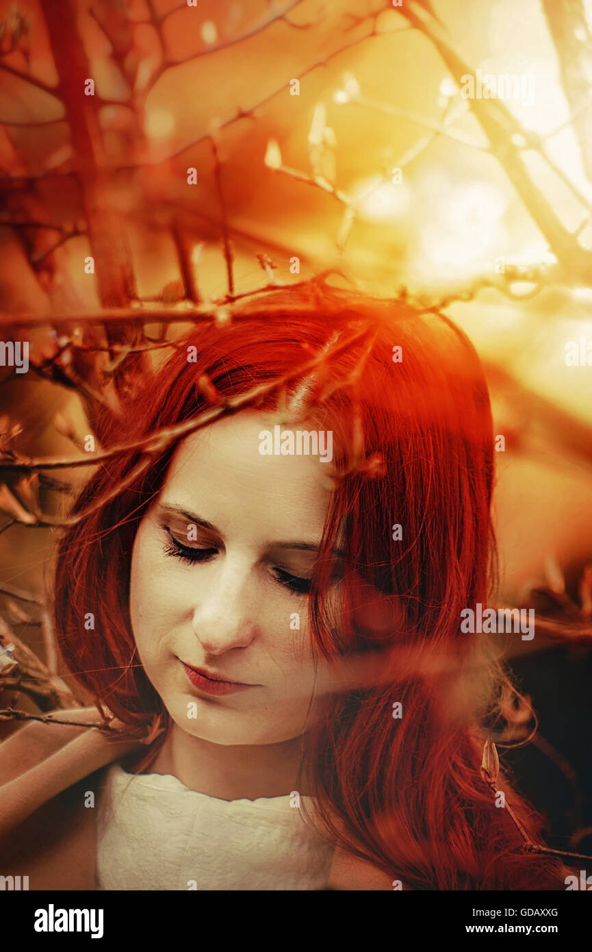 beautiful red hair young woman in nature looking down Stock Photo - Alamy