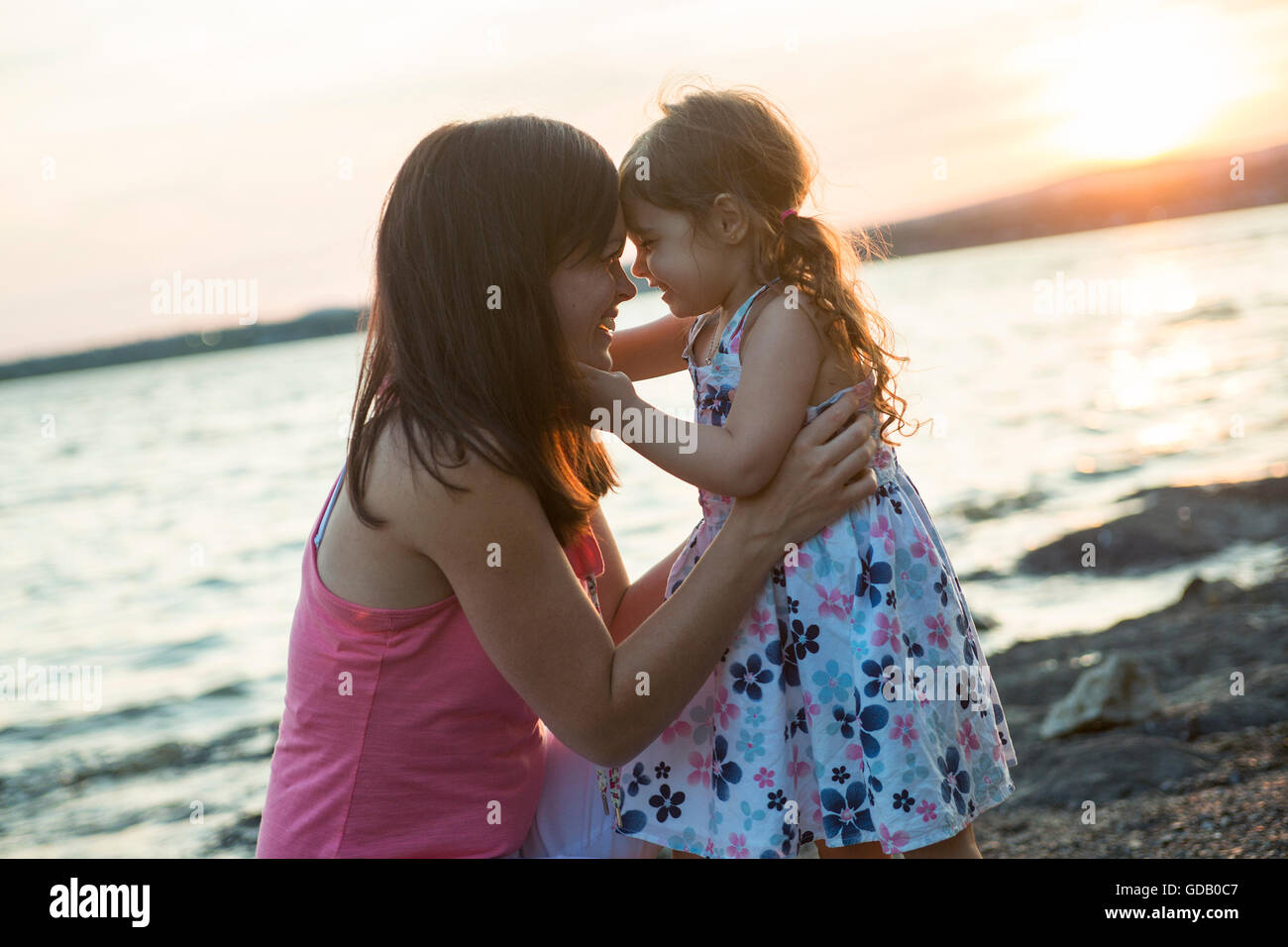 happy joyful mother with is child sunset Stock Photo - Alamy