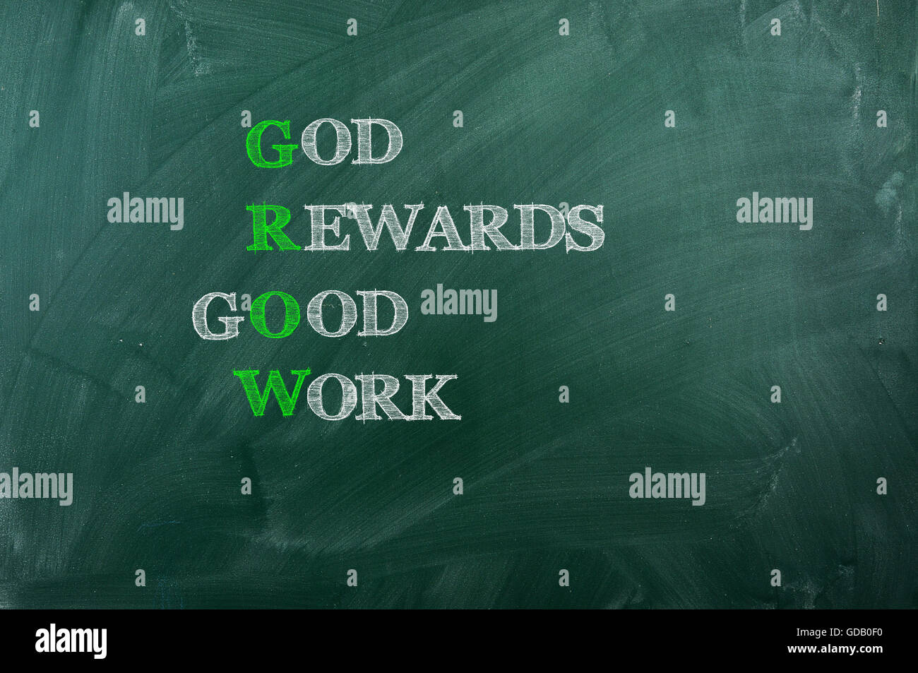 GROW acronym "God Reward Good Work" , written with chalk on blackboard ...