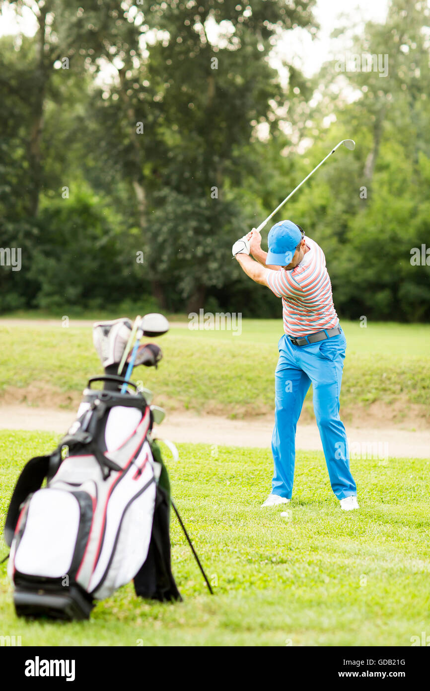 Man playing golf on the golf course Stock Photo - Alamy