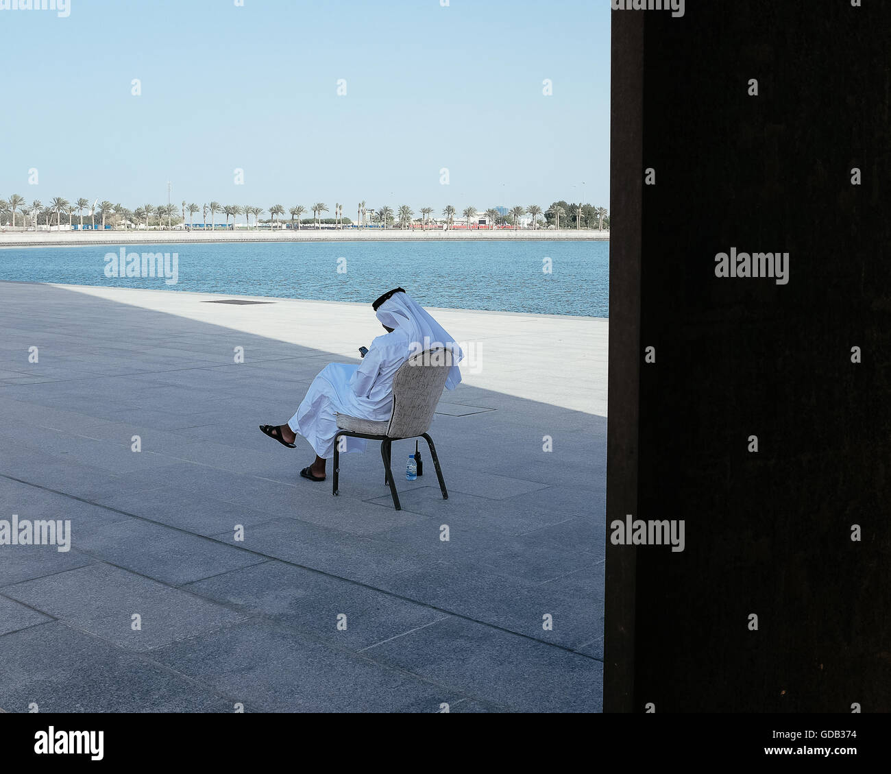 Qatari Man checks his mobile phone in front of Richard Serra's "7 ...
