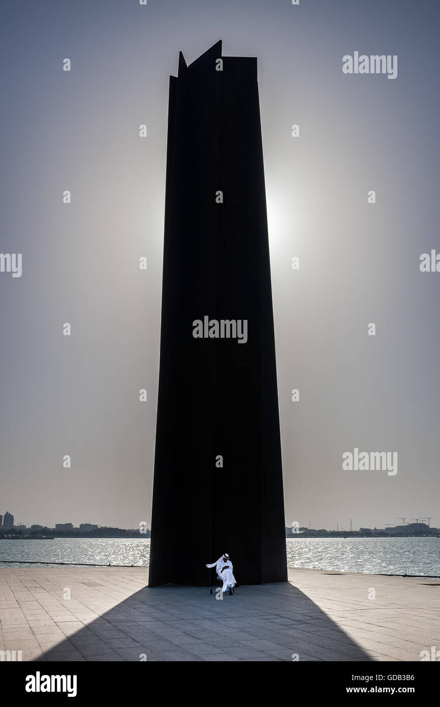 Qatari Man checks his mobile phone in front of Richard Serra's "7 ...