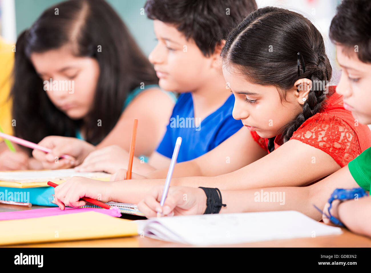 4 kids Girls and Boys School Student Studying in a Classroom Stock ...
