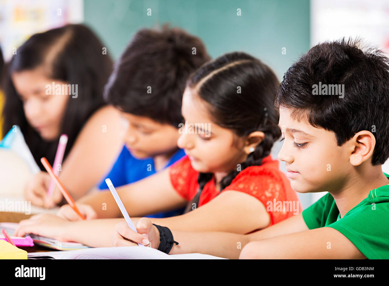 4 kids Girls and Boys School Student Studying in a Classroom Stock ...