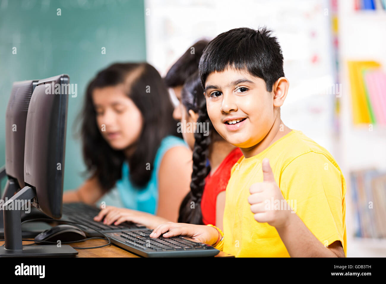 4 kids Boys and Girls School Student Sitting Classroom Computer Stock ...
