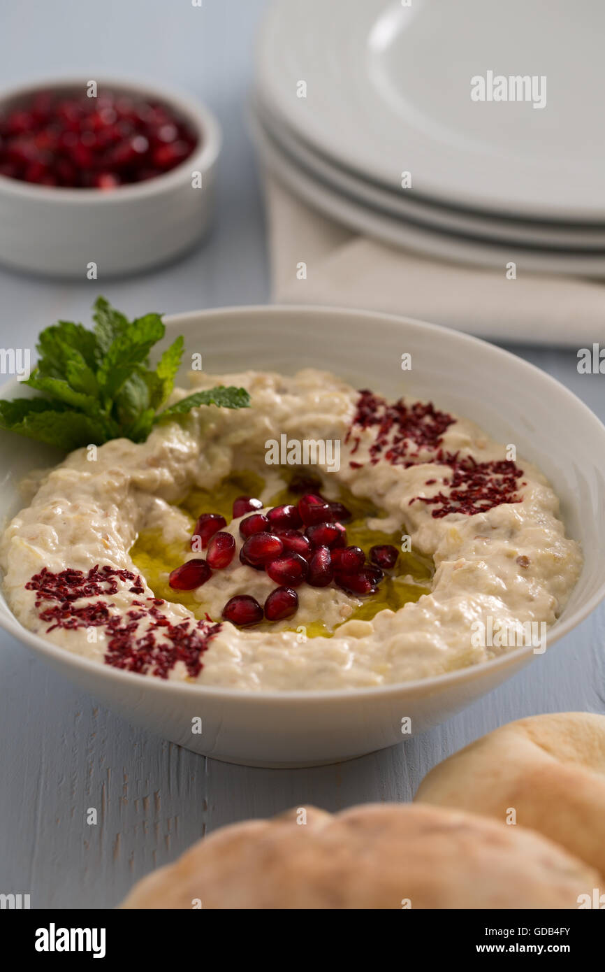 Moutabel, with bread, pomegranate seeds and empty plates Stock Photo ...
