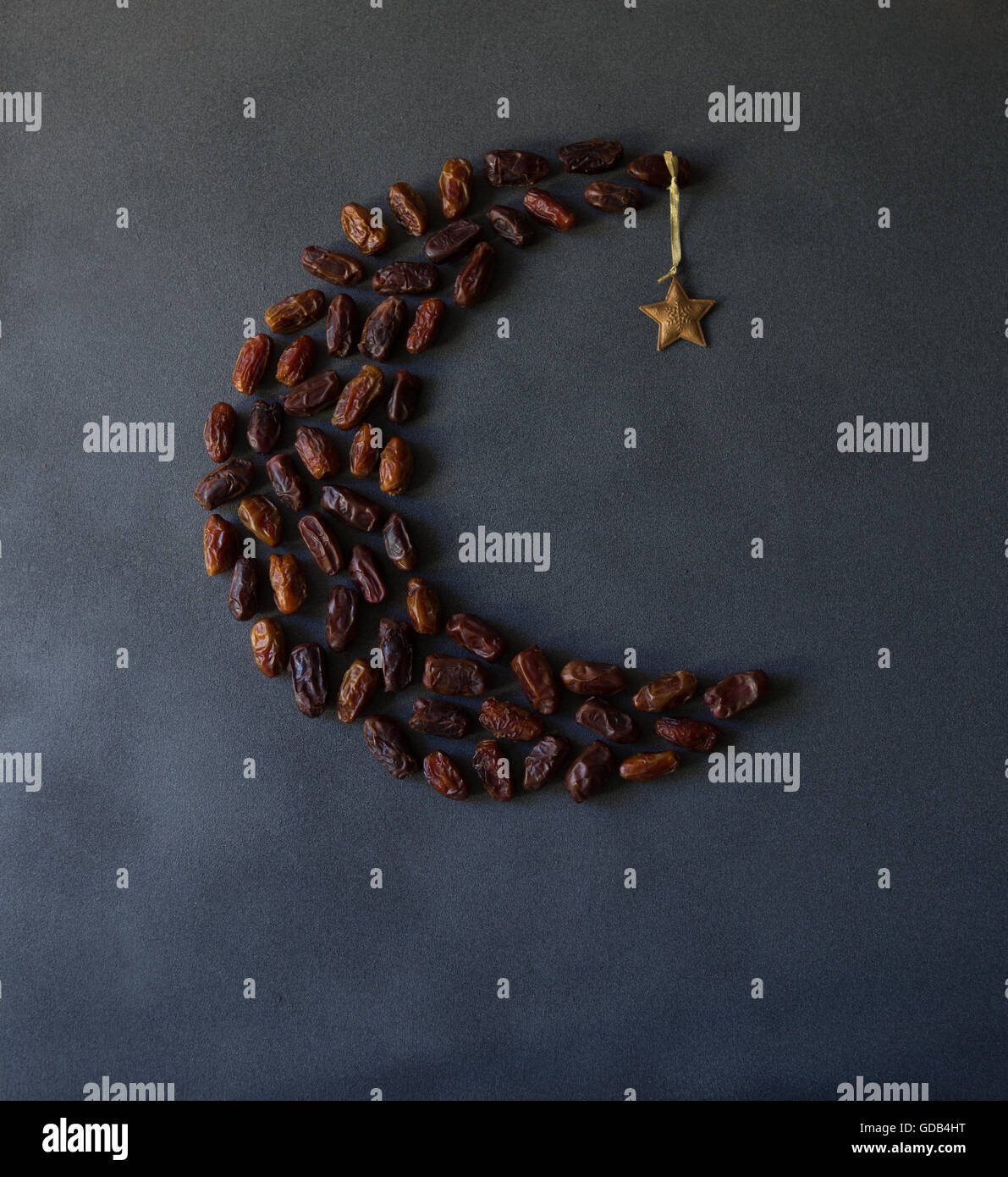 Dates in the shape of a crescent moon, with a gold star hanging from it ...
