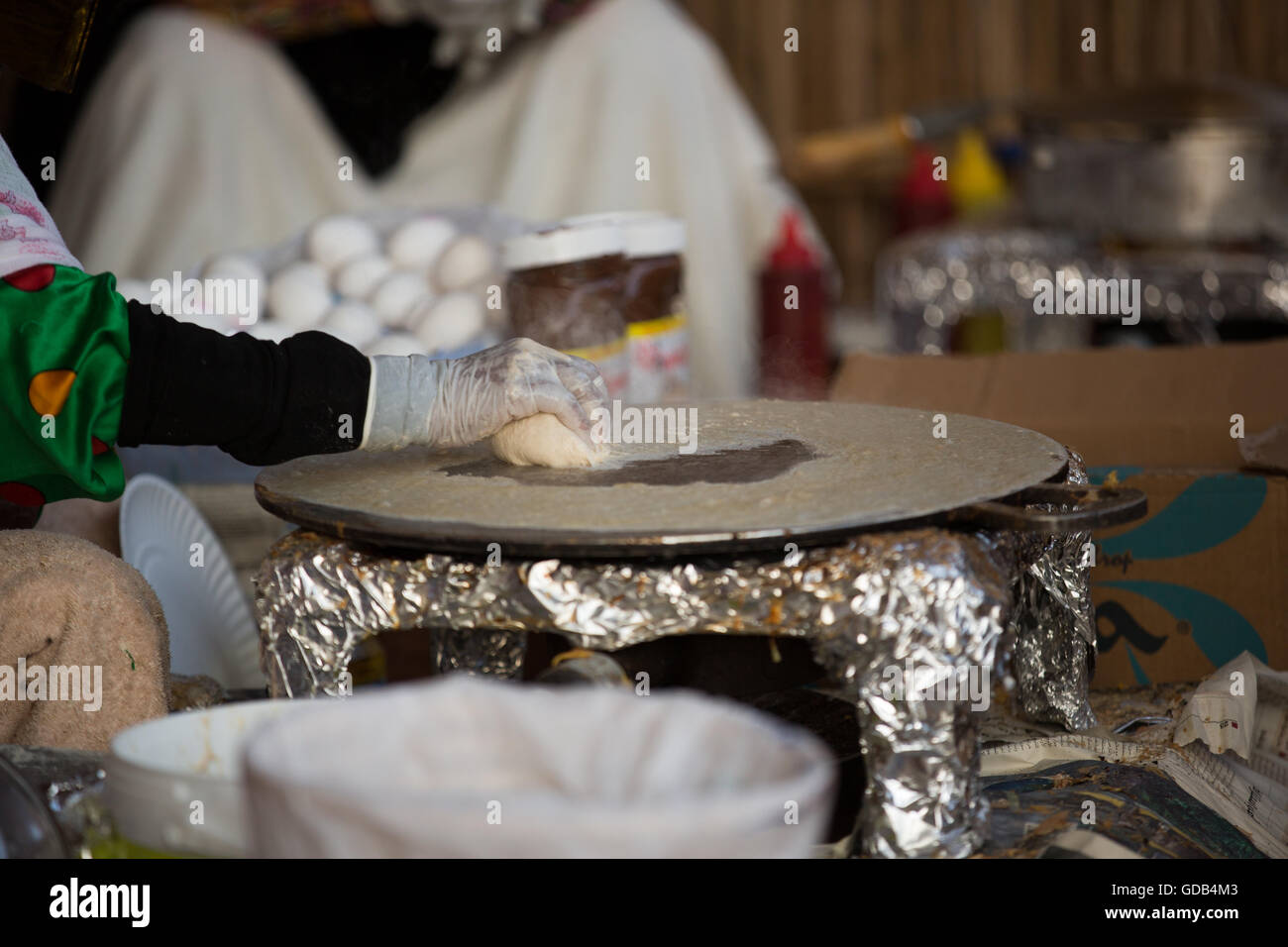 A woman making chabab, a traditional Emirati pancake at the Heritage ...