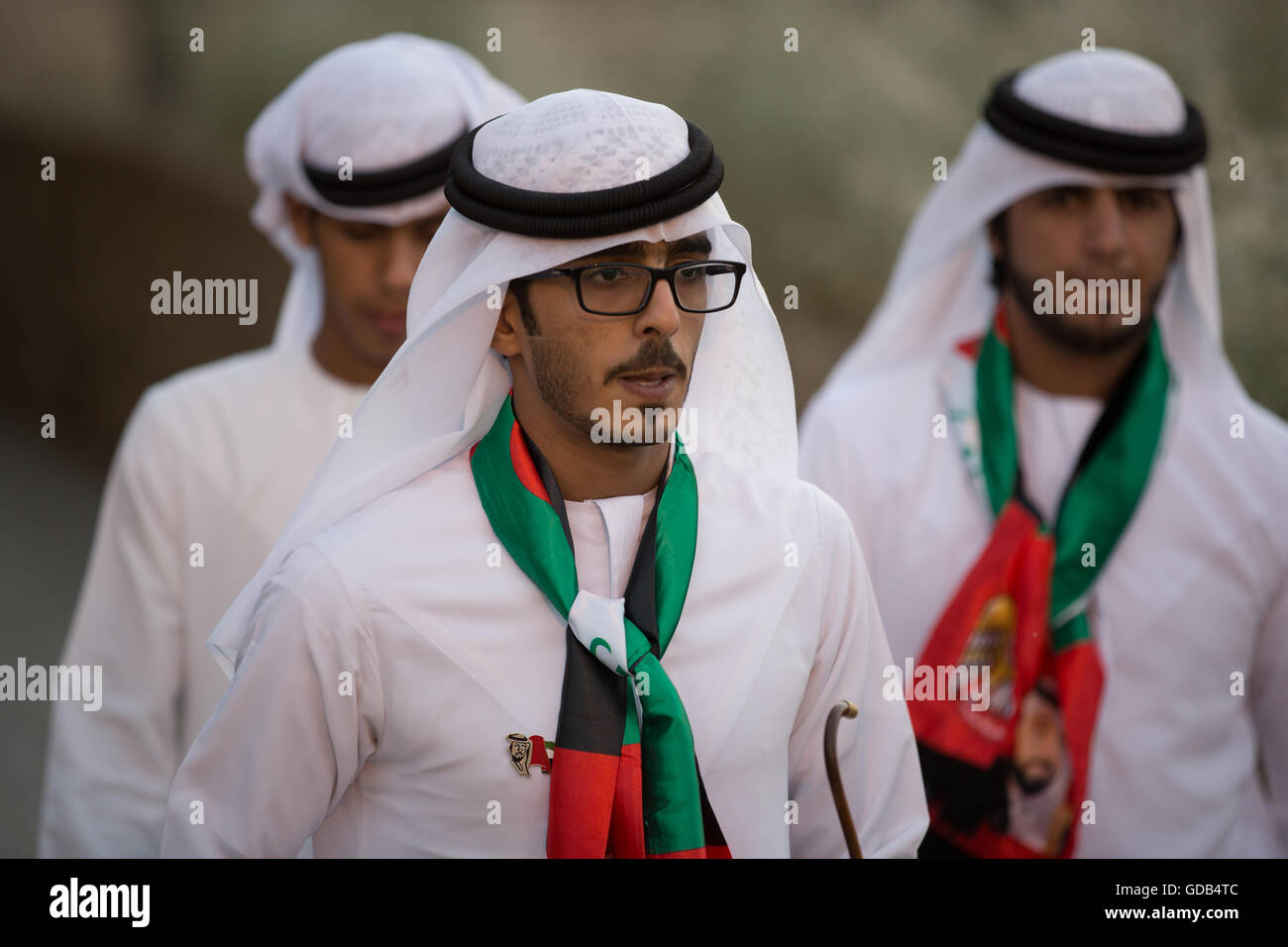 Three Emirati men in National dress with UAE flag scarves, at the ...