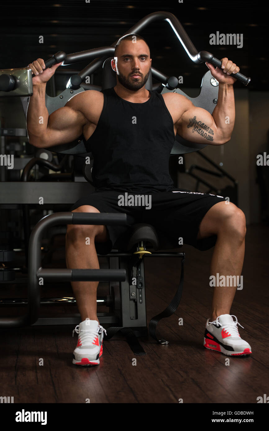 Big Man In The Gym And Exercising Back On Machine - Muscular Athletic ...