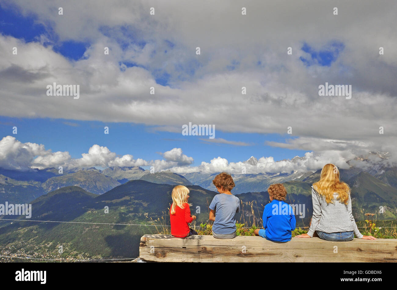 Kids sitting on viewpoint in mountains, french Alps Stock Photo - Alamy