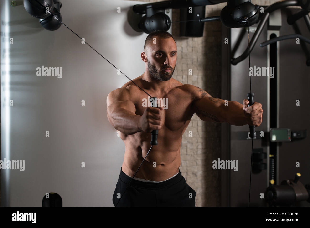 Big Man Is Working On His Chest With Cable Crossover In A Modern Gym ...