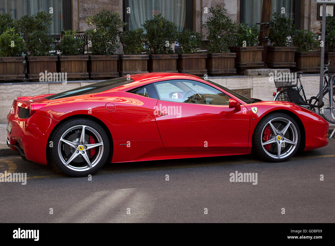 Luxury red Ferrari Italian supercar in front of Principe di Piemonte ...