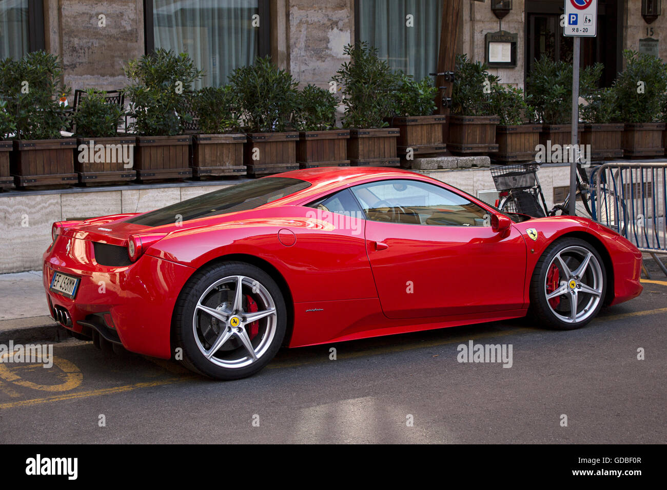 Luxury red Ferrari Italian supercar in front of Principe di Piemonte ...
