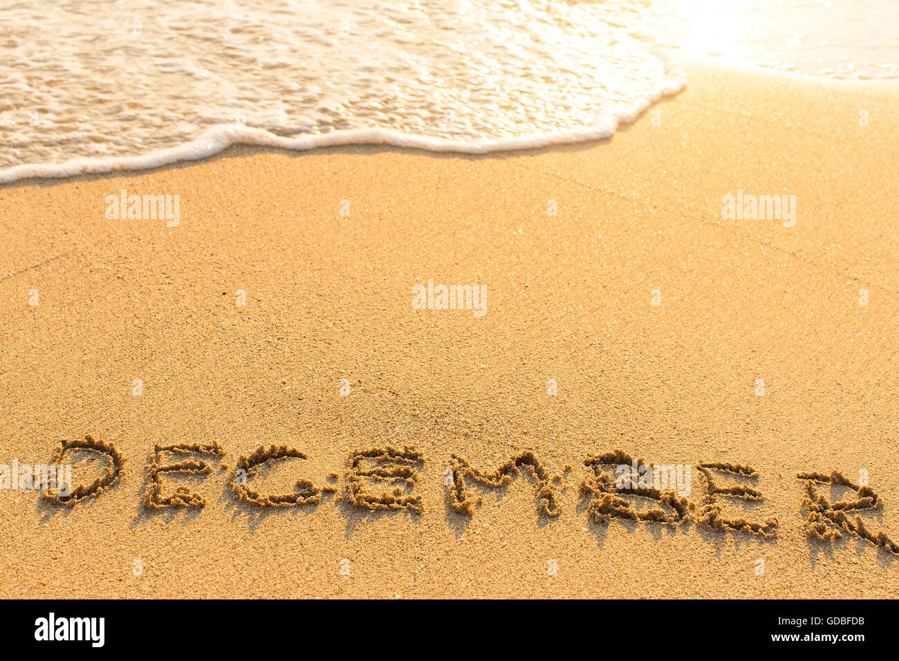 December - drawn by hand on a golden sandy sea beach Stock Photo - Alamy