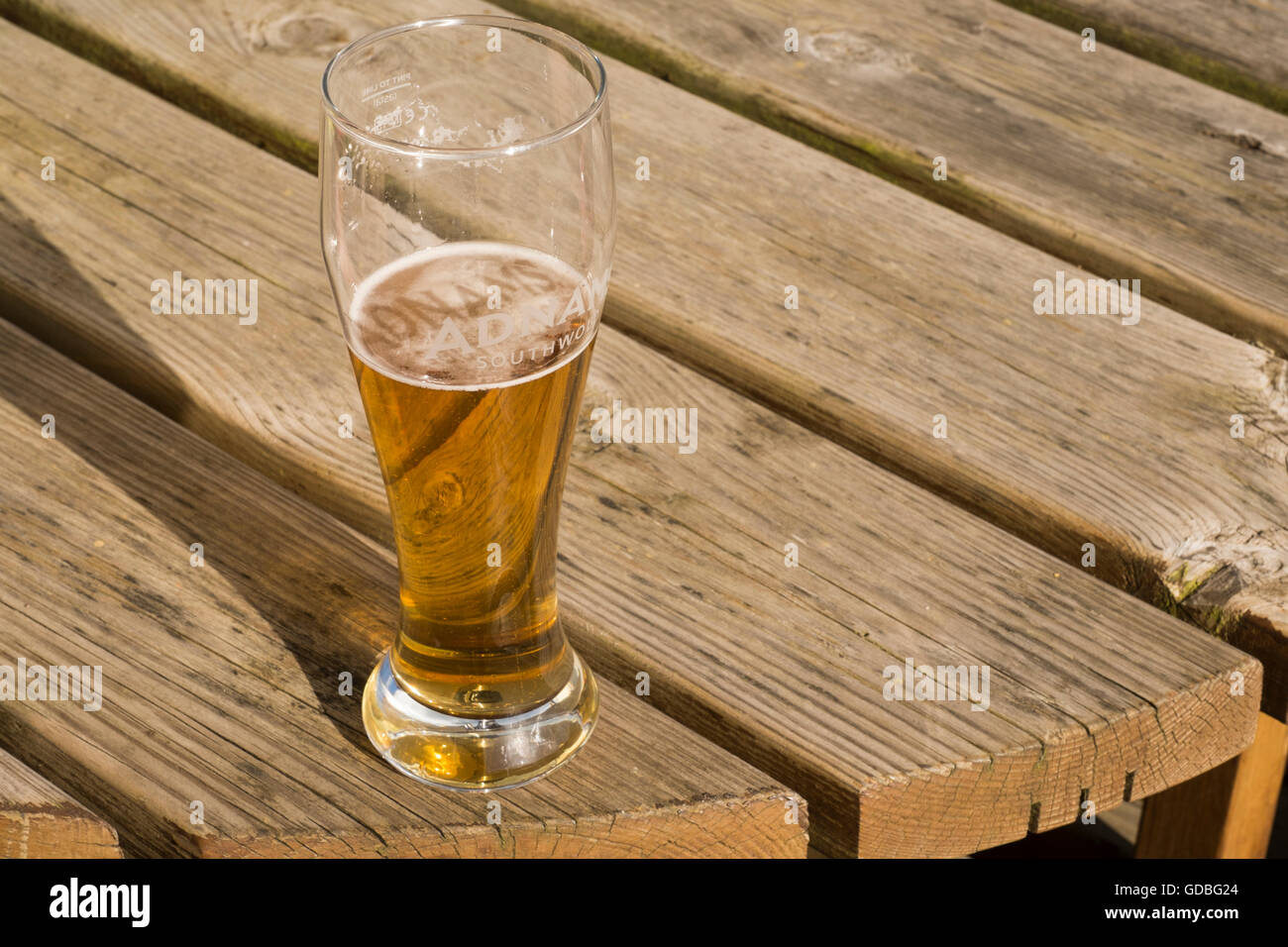 Pint of Adnams beer with a shadow from the glass across the beer Stock ...