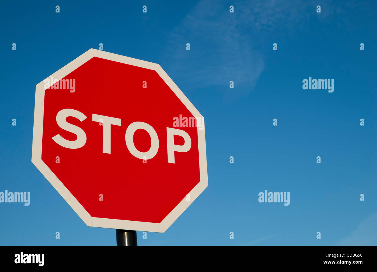 Red stop sign with a blue sky Stock Photo - Alamy
