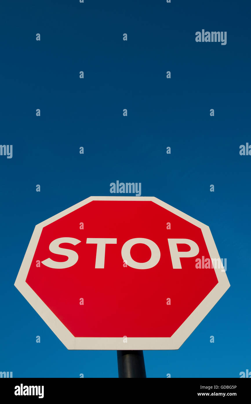 Red stop sign with a blue sky Stock Photo - Alamy