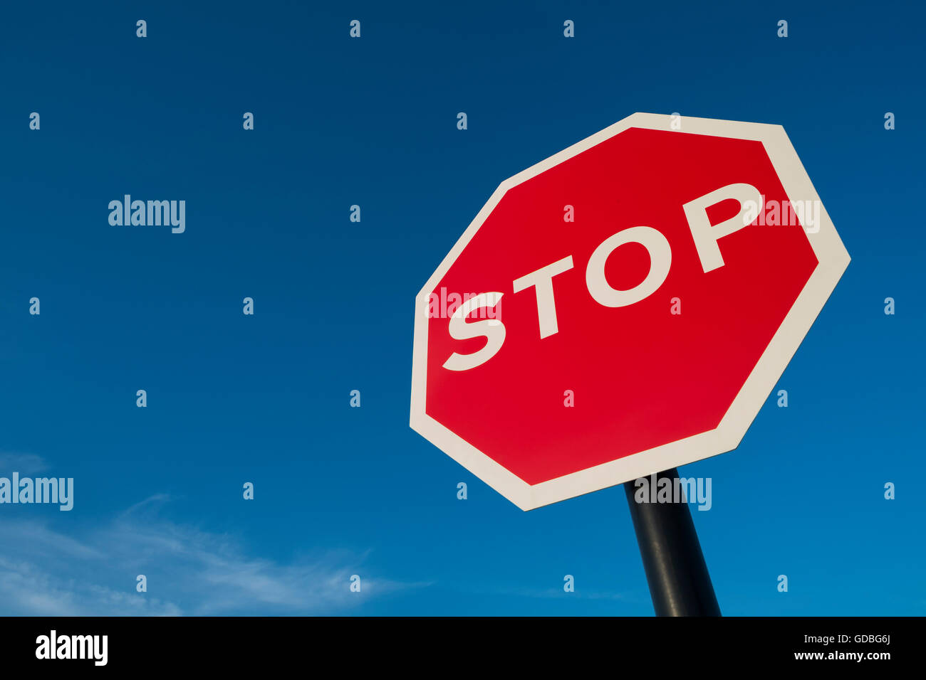 Red stop sign with a blue sky Stock Photo - Alamy