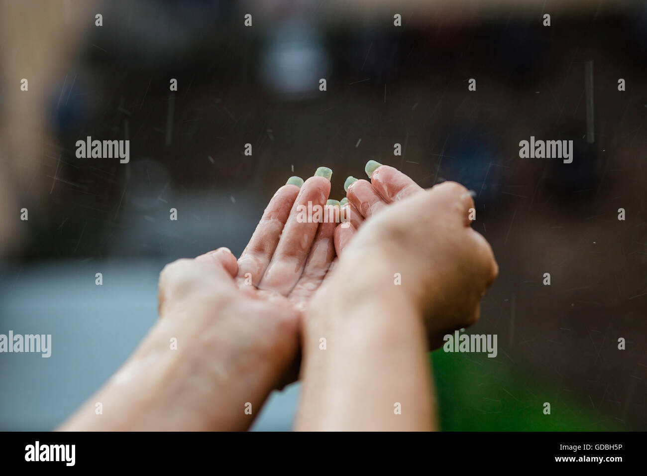 Hands catching clean falling rain water close up. Environmental and ...