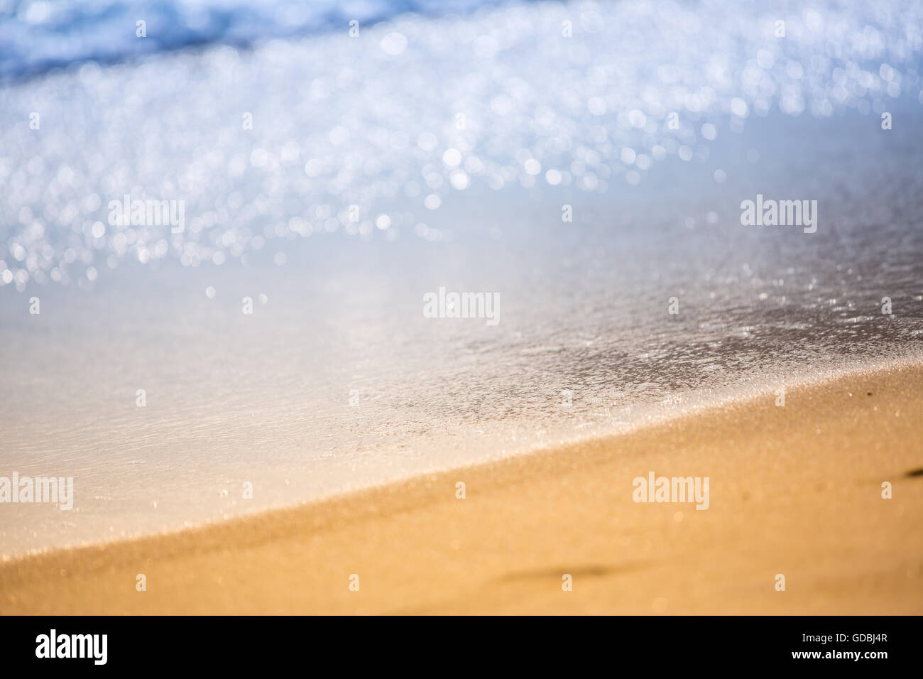 Sunset reflection on beach Stock Photo - Alamy