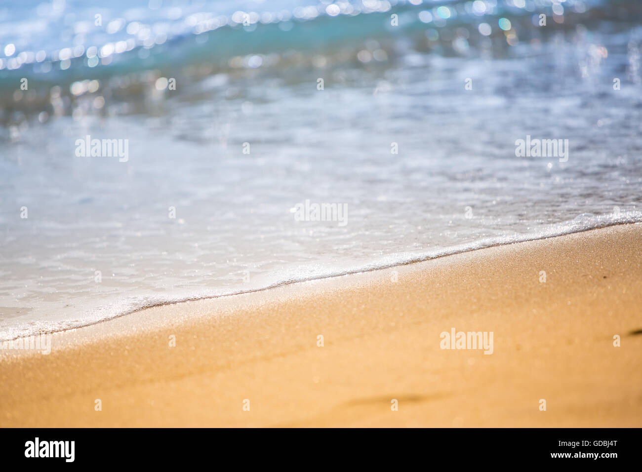 Sunset reflection on beach Stock Photo - Alamy