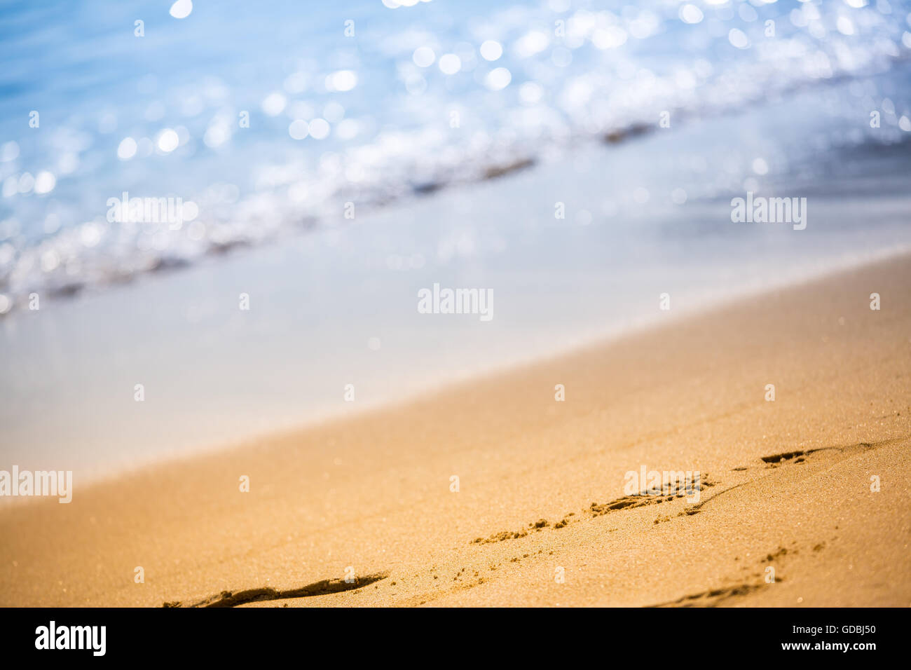 Sunset reflection on beach Stock Photo - Alamy