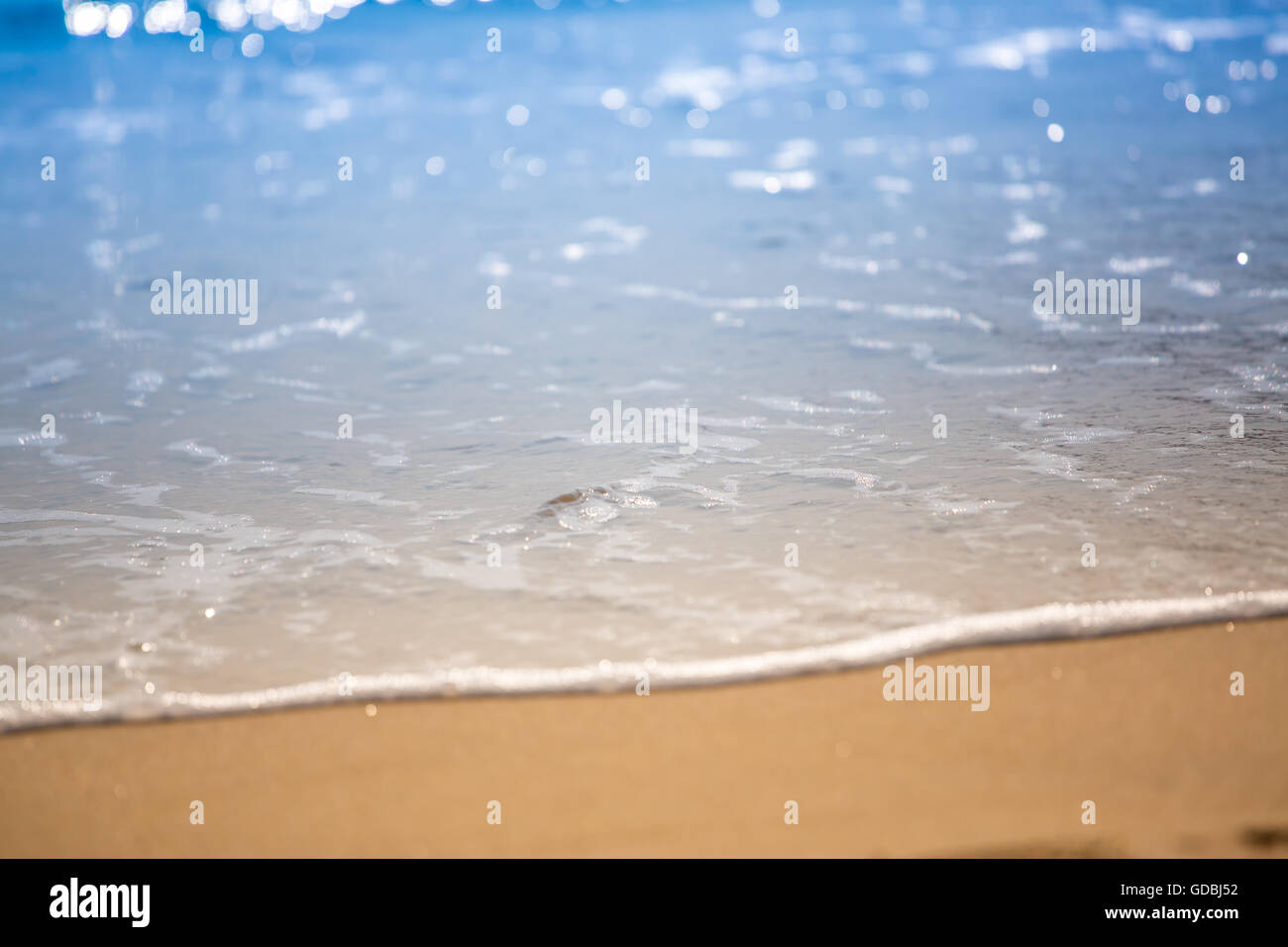 Sunset reflection on beach Stock Photo - Alamy