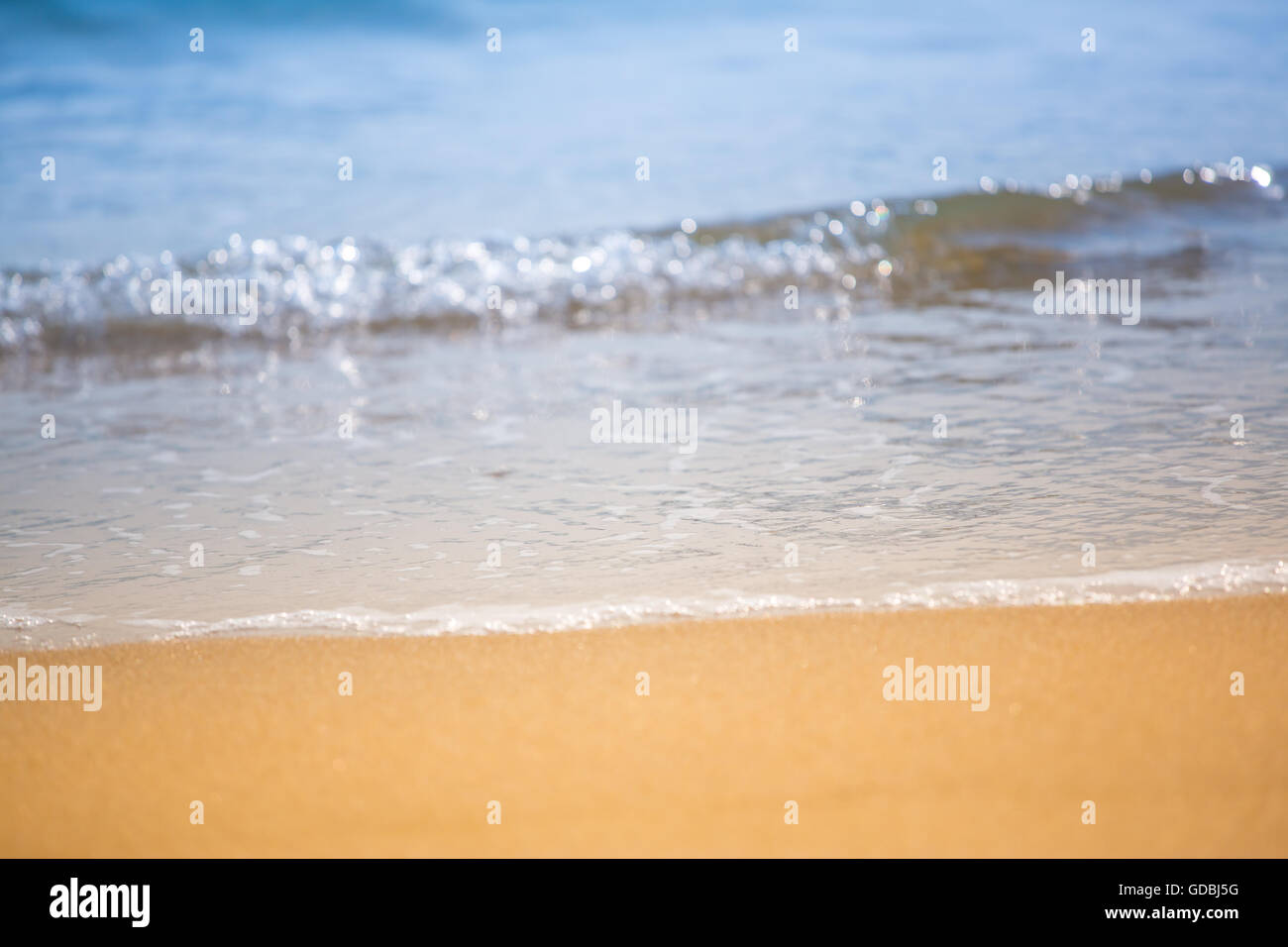 Sunset reflection on beach Stock Photo - Alamy