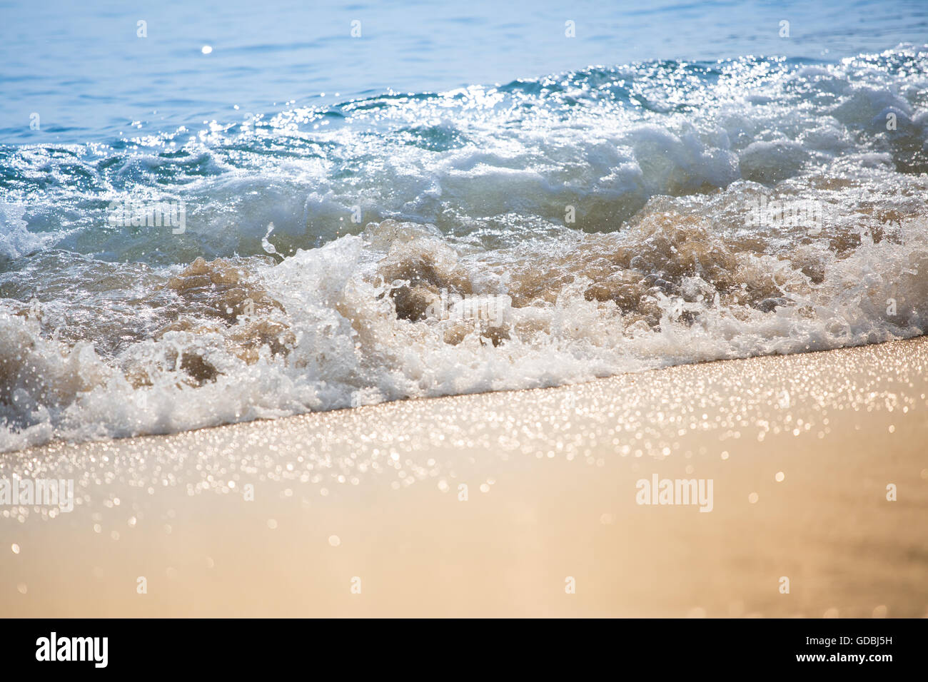 Sunset reflection on beach Stock Photo - Alamy
