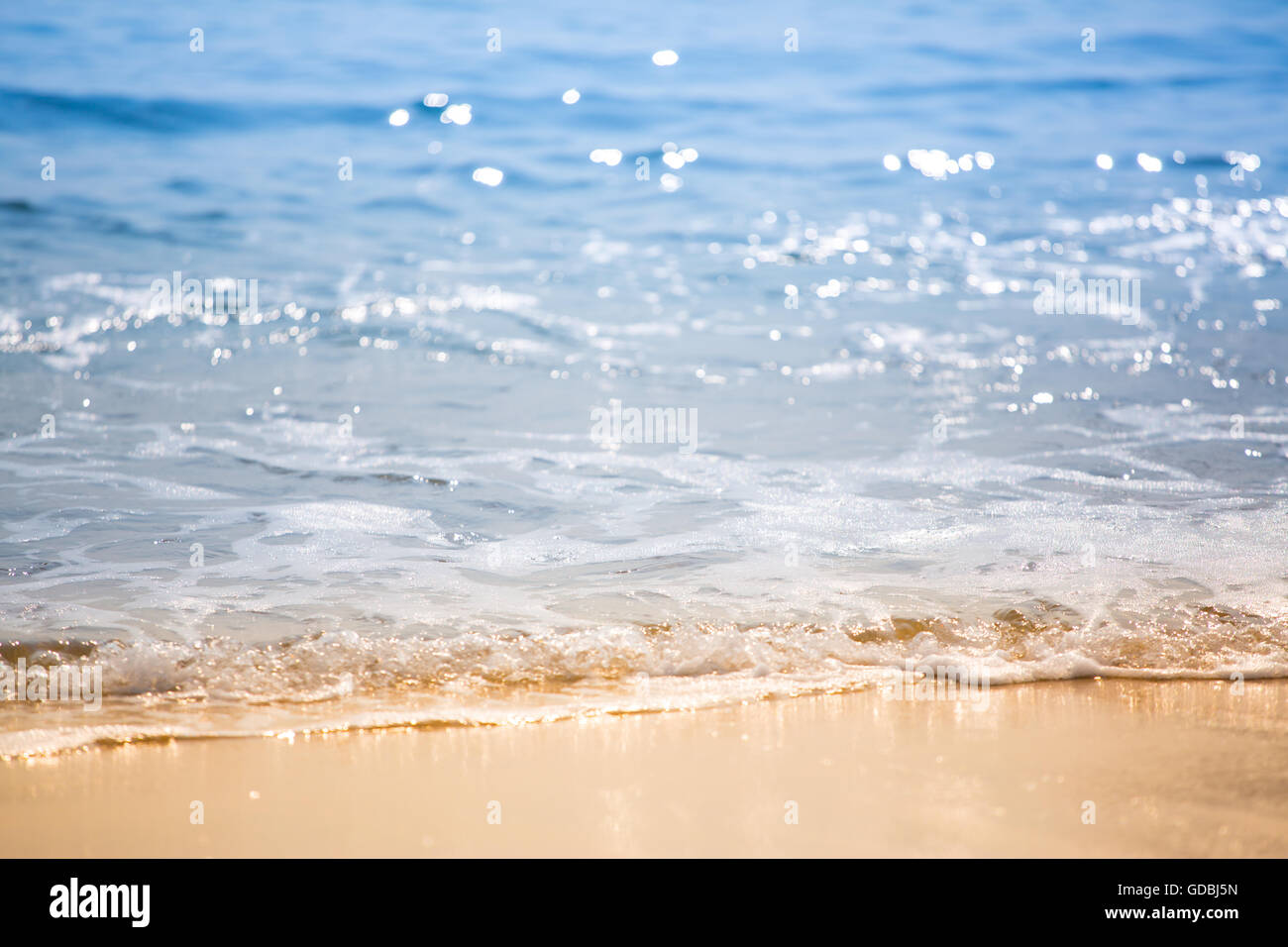 Sunset reflection on beach Stock Photo - Alamy
