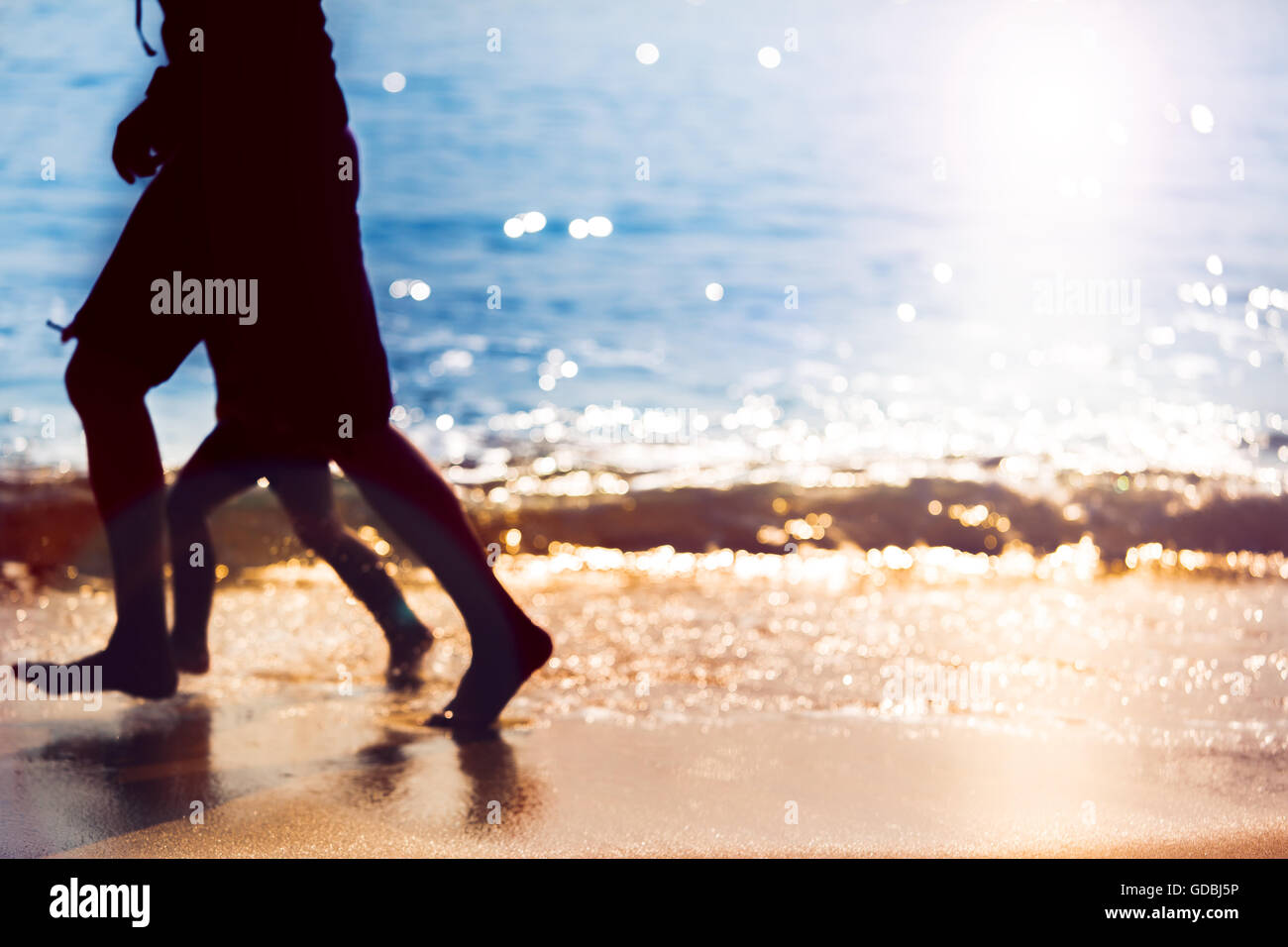 Sunset reflection on beach Stock Photo - Alamy
